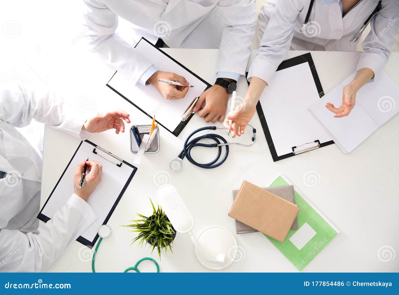 Doctors Having Meeting at Table in Office Stock Photo - Image of ...