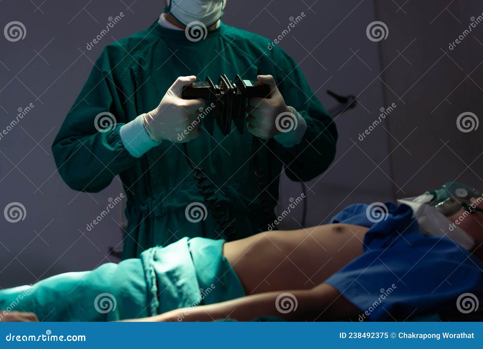 Doctors Holding Paddles and about To Perform CPR on a Patient Using a ...