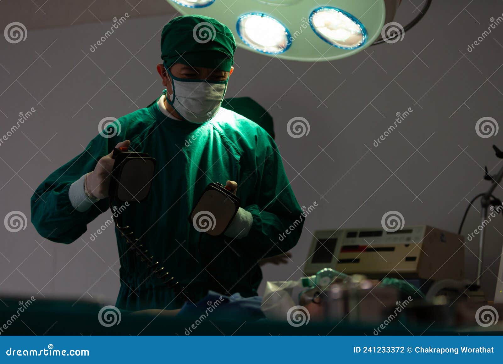 Doctors Holding Paddles and about To Perform CPR on a Patient Using a ...