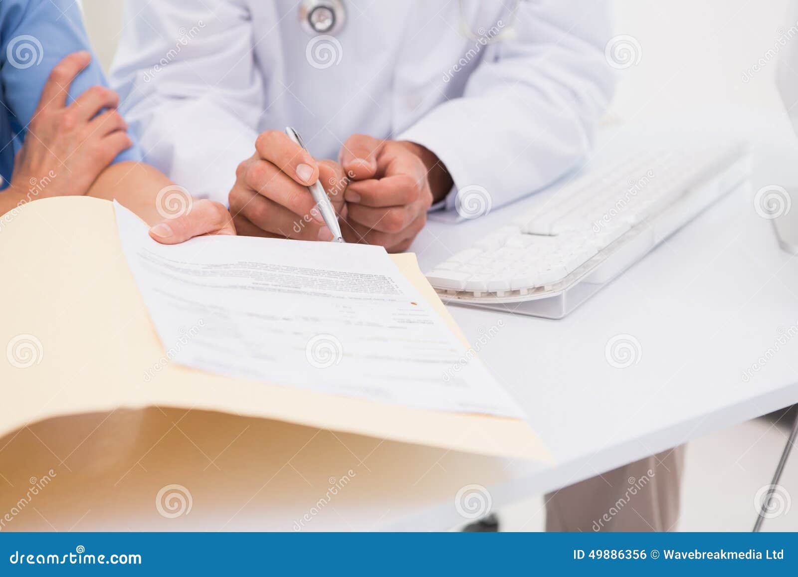 Doctors looking at files stock photo. Image of pointing - 49886356