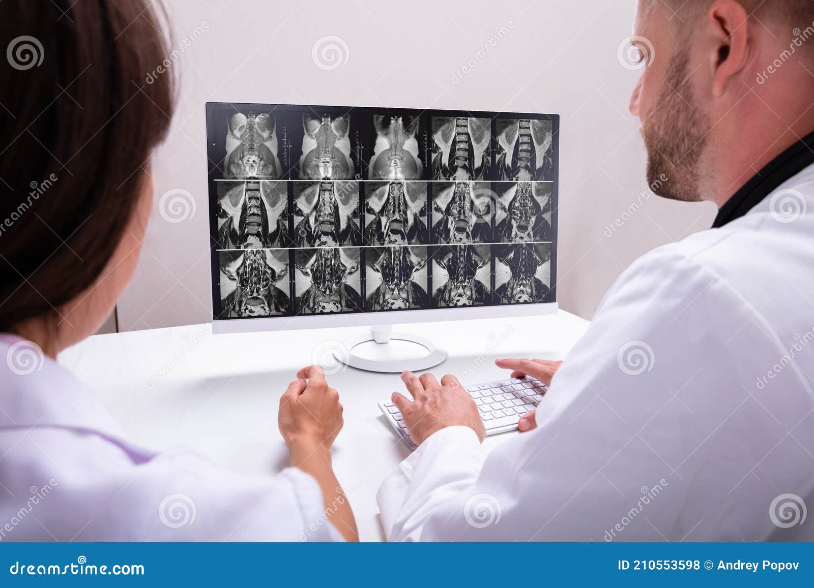 Doctors Looking at an MRI Scan at Computer Stock Photo - Image of ...