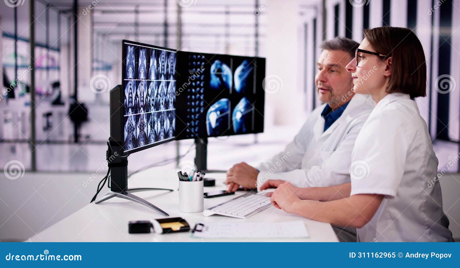 Doctors Looking at an MRI Scan at Computer Stock Image - Image of ...