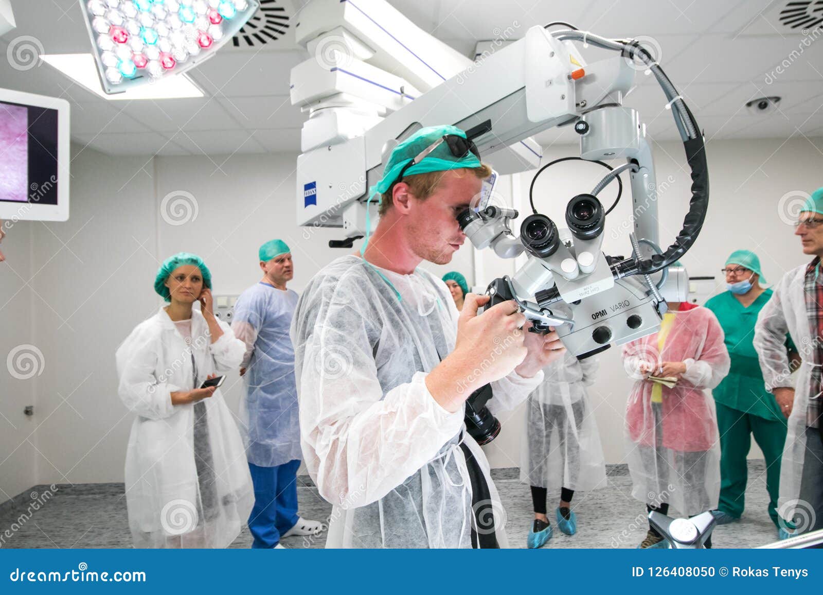 Doctors Looking into the Microscope in Surgery Room Editorial Image ...