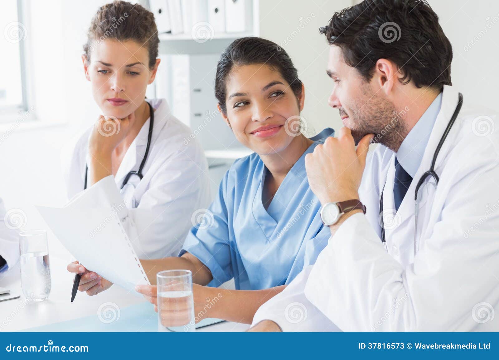 Doctors and Nurse Discussing Over Document Stock Image - Image of nurse ...