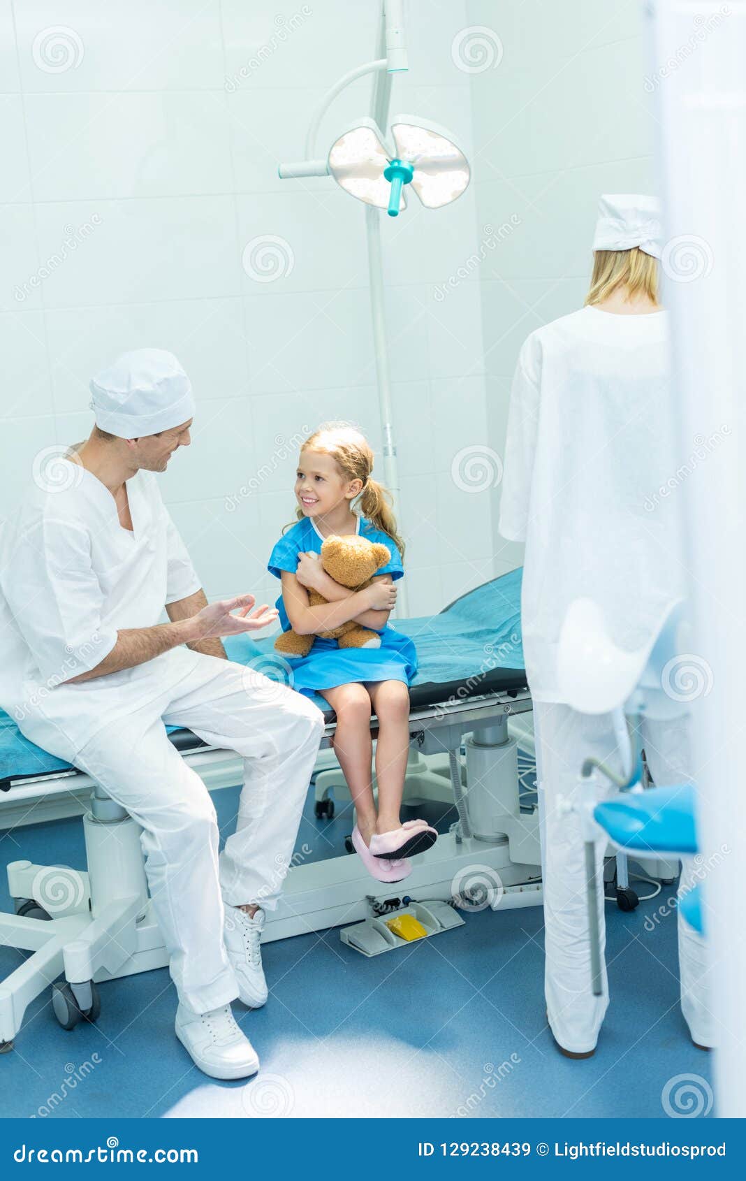 Doctors Preparing Smiling Kid for Surgery Stock Image - Image of ...