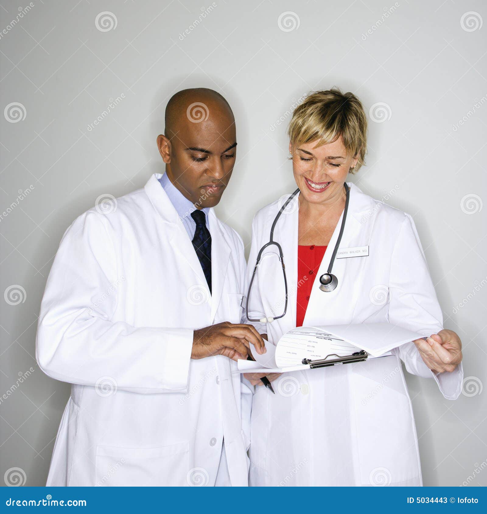 Doctors reading paperwork. stock image. Image of african - 5034443