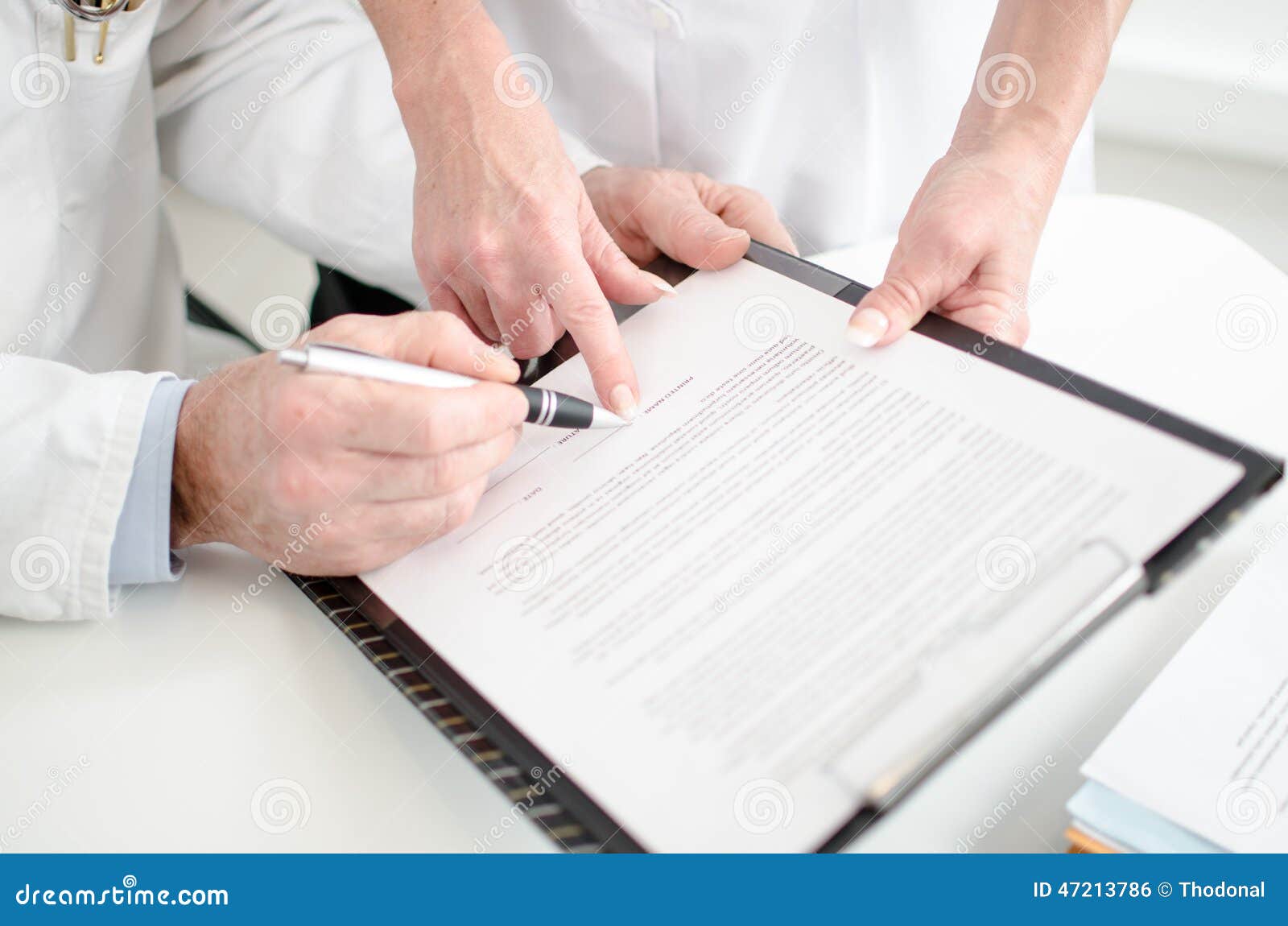Doctors Signing a Medical Report Stock Photo - Image of writing, health ...