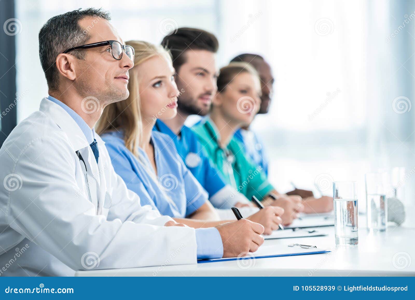 Doctors sitting at table stock image. Image of teamwork - 105528939