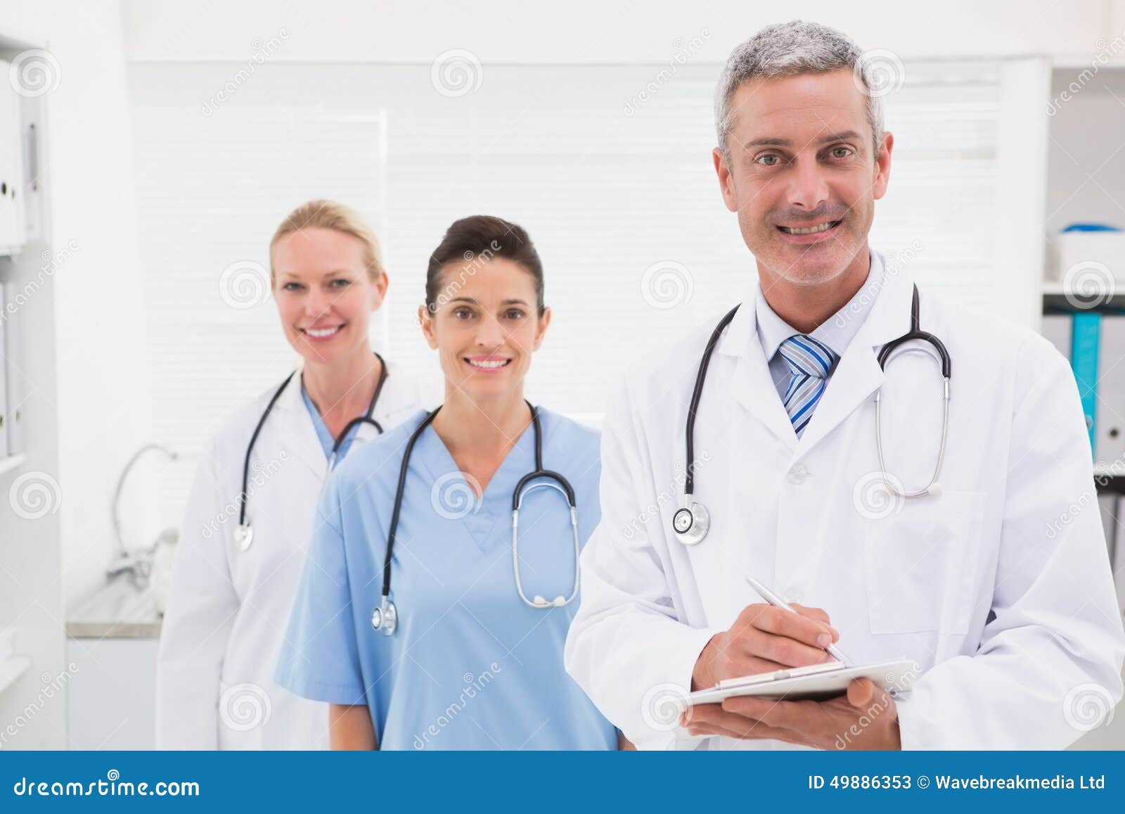 Doctors smiling at camera stock image. Image of happy - 49886353