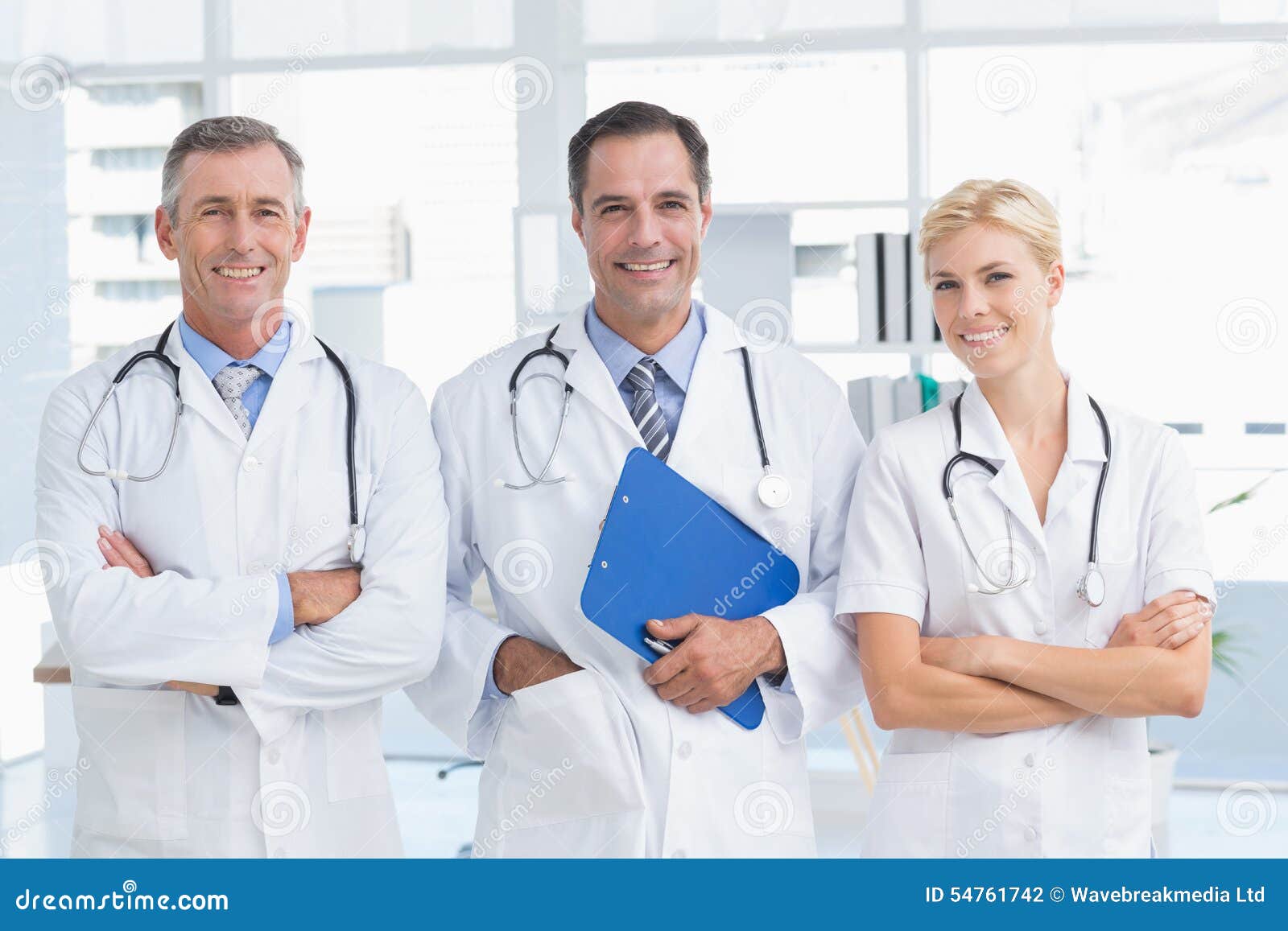 Doctors smiling at camera stock photo. Image of stethoscope - 54761742