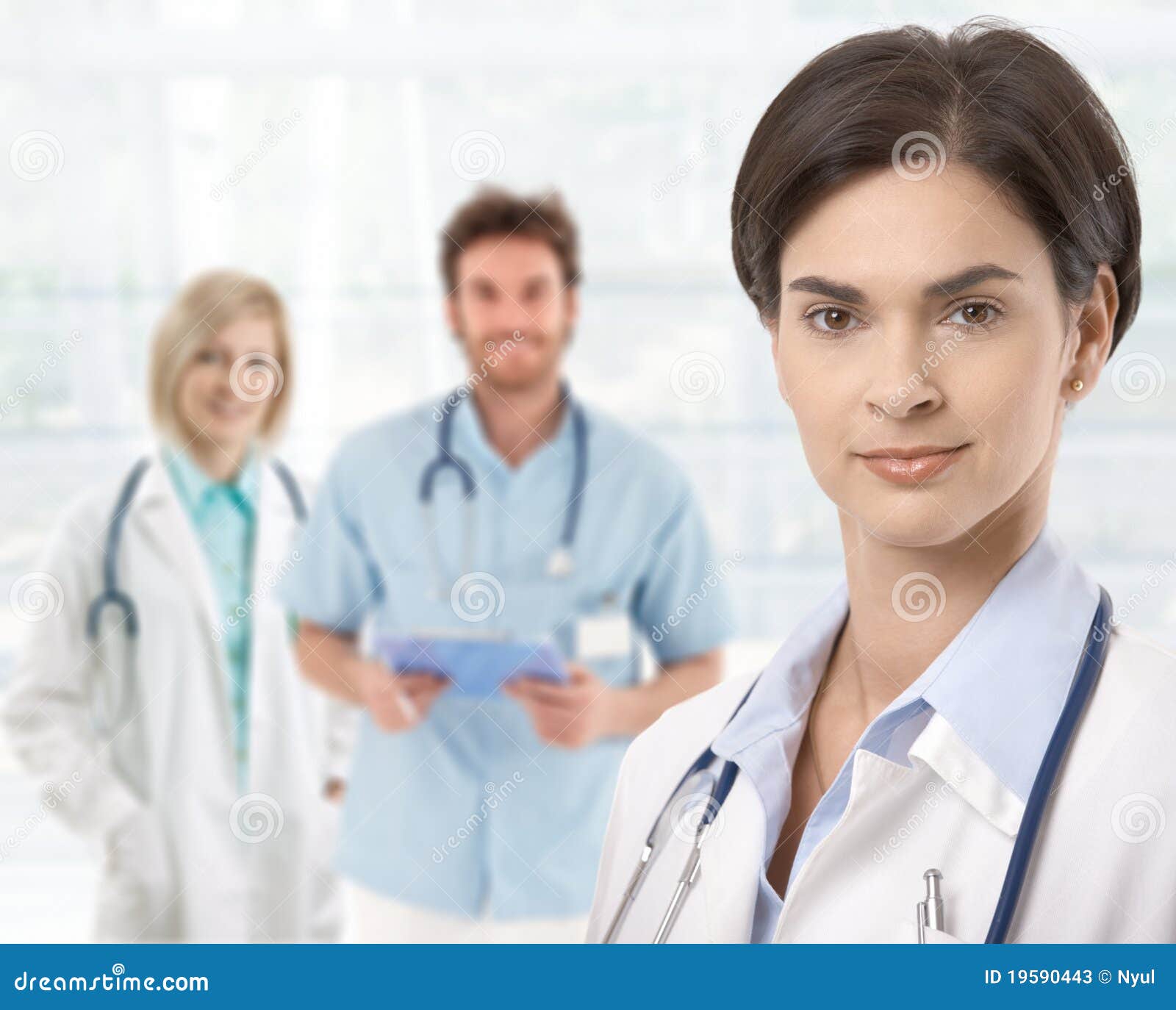 Doctors standing in lobby stock image. Image of casual - 19590443