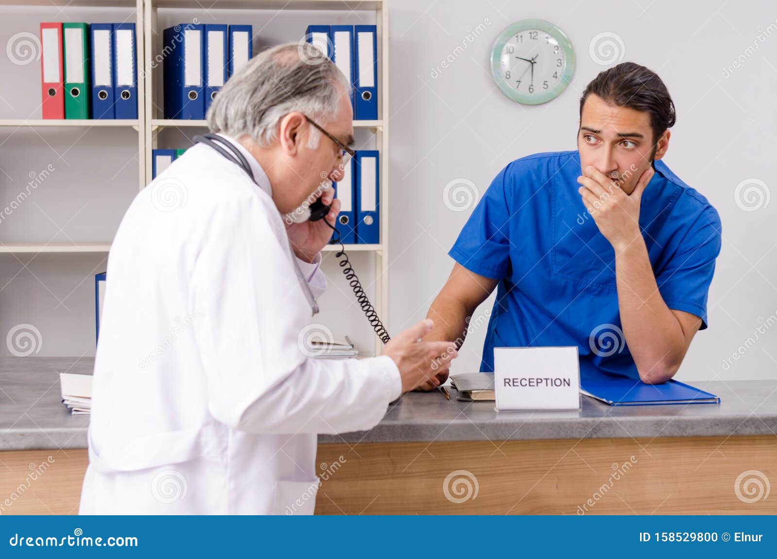 Two Doctors Talking at the Reception in Hospital Stock Photo - Image of ...