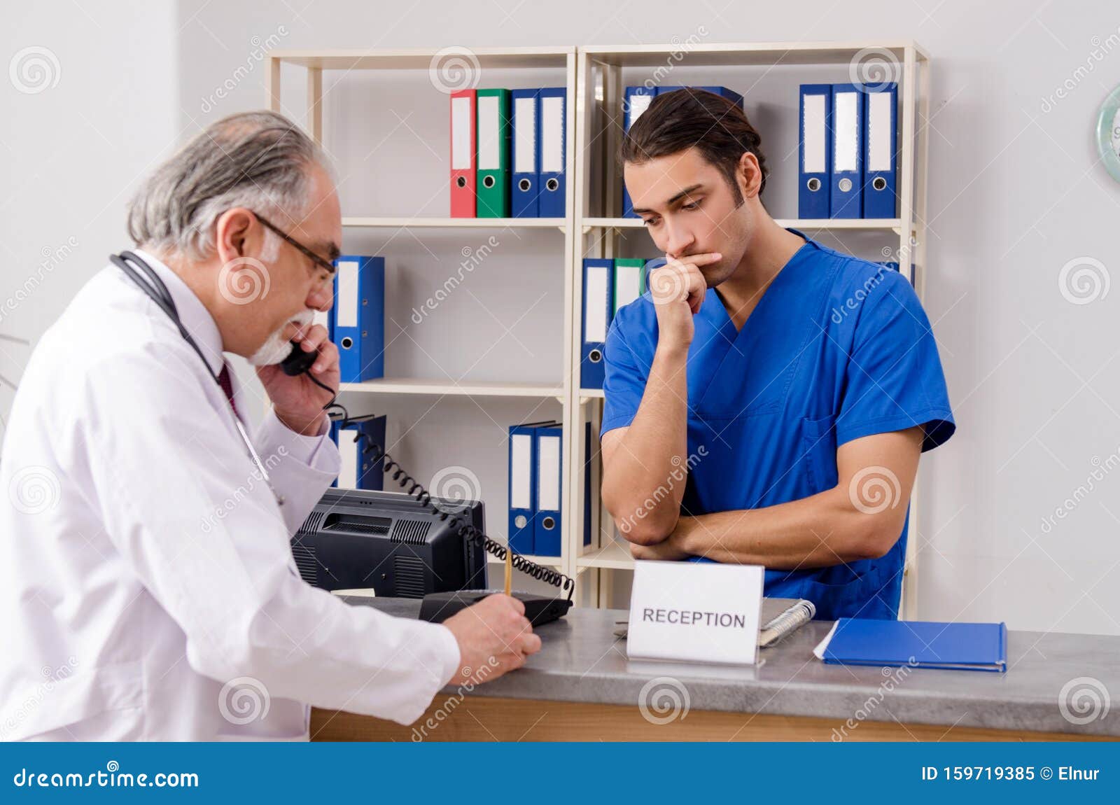 Two Doctors Talking at the Reception in Hospital Stock Image - Image of ...