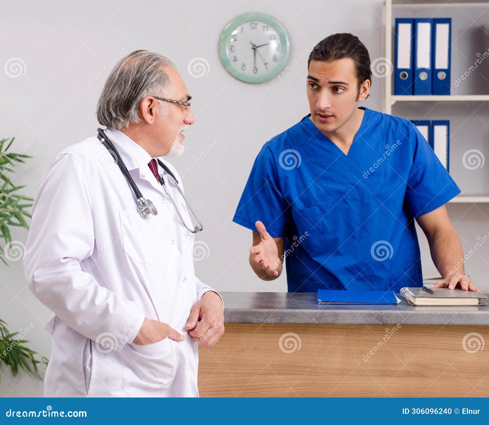Two Doctors Talking at the Reception in Hospital Stock Photo - Image of ...
