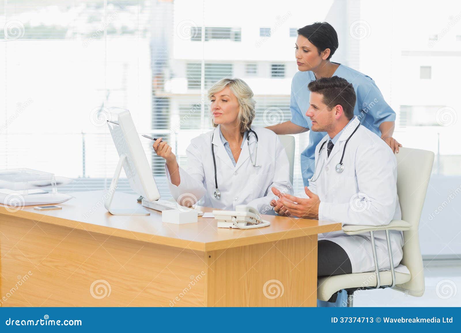 Doctors Using Computer Together at Medical Office Stock Image - Image ...