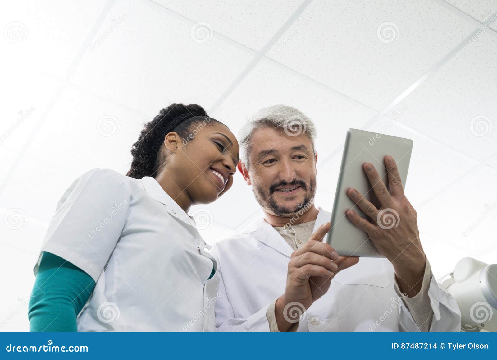 Doctors Using Digital Tablet in Examination Room Stock Photo - Image of ...