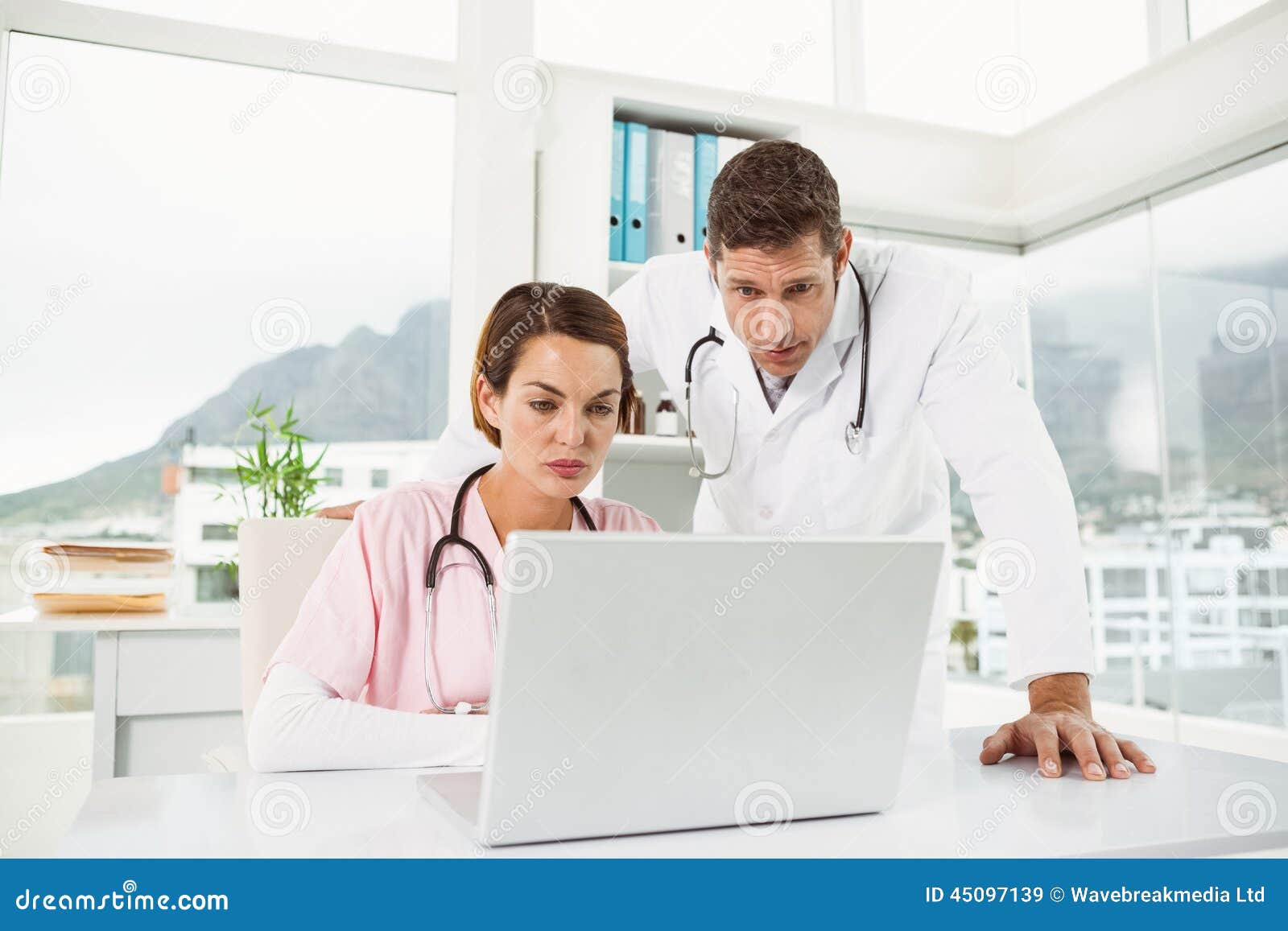 Doctors Using Laptop Together at Medical Office Stock Image - Image of ...
