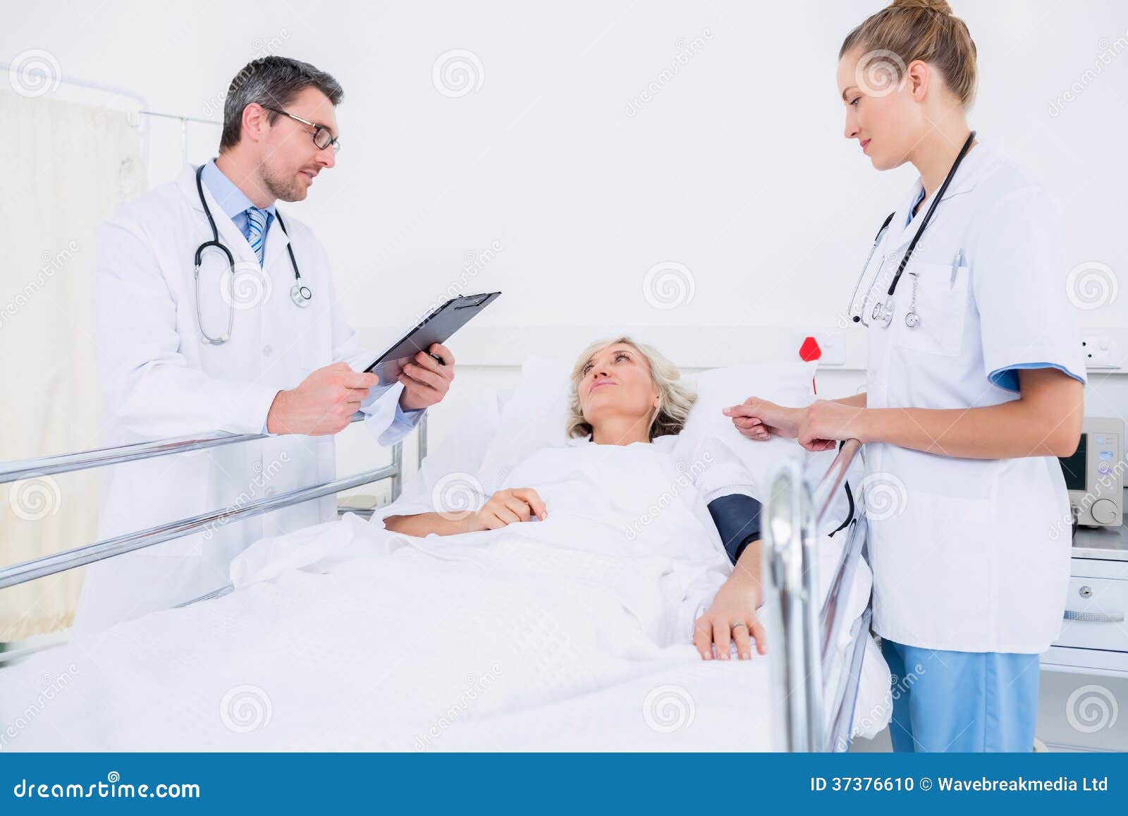 Doctors Visiting a Female Patient in Hospital Stock Photo - Image of ...