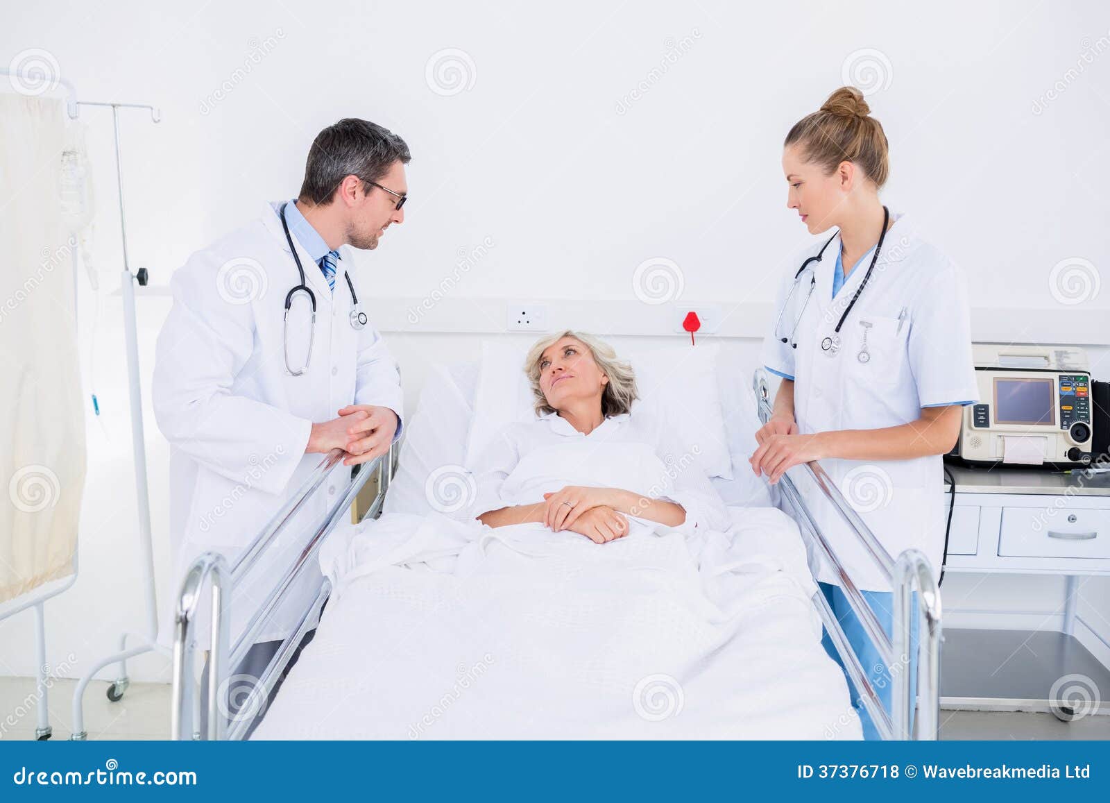 Doctors Visiting a Female Patient in Hospital Stock Photo - Image of ...