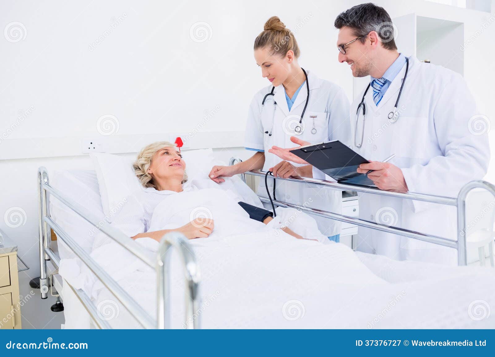 Doctors Visiting a Female Patient in Hospital Stock Image - Image of ...