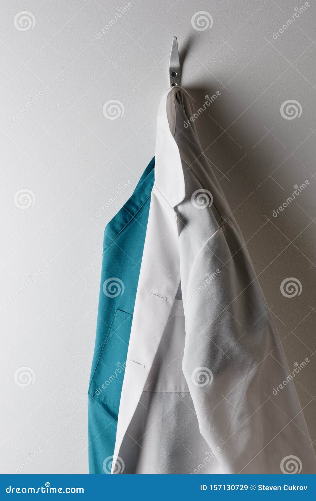 Doctors White Lab Coat and Green Scrubs Hanging on a Hook Stock Image ...
