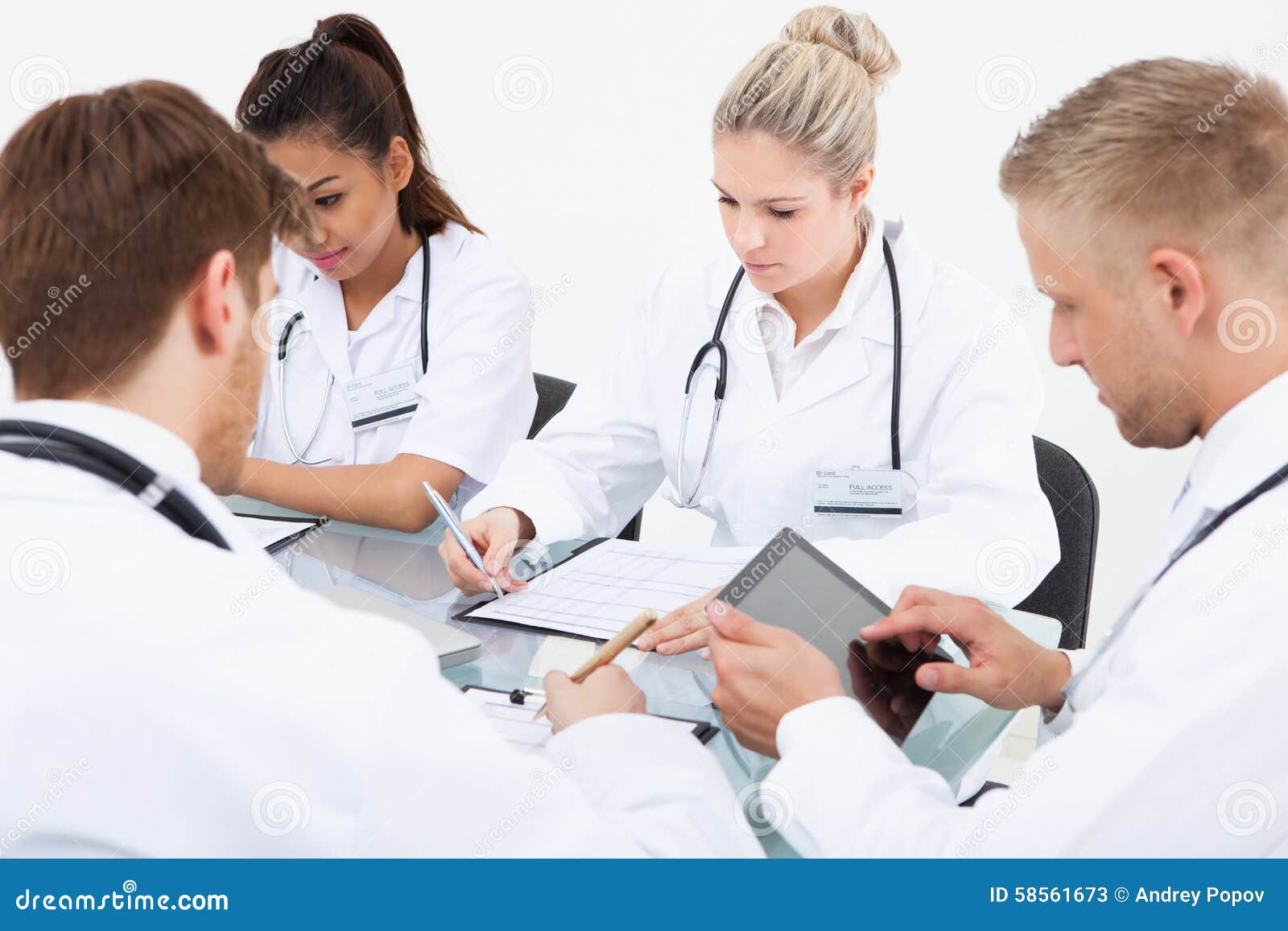 Doctors Working at Desk stock image. Image of examining - 58561673