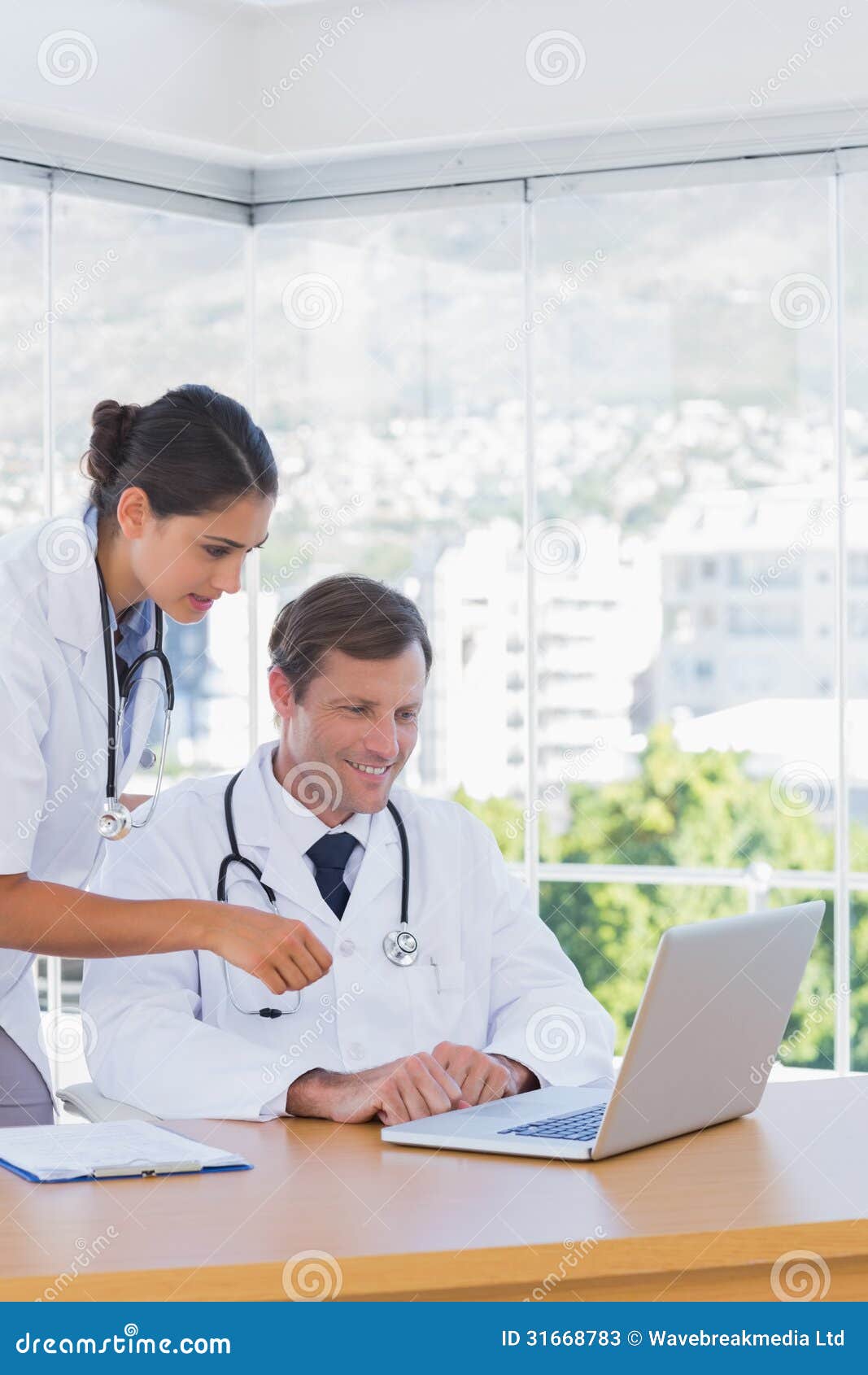 Doctors Working Together on a Laptop Stock Image - Image of clinic ...