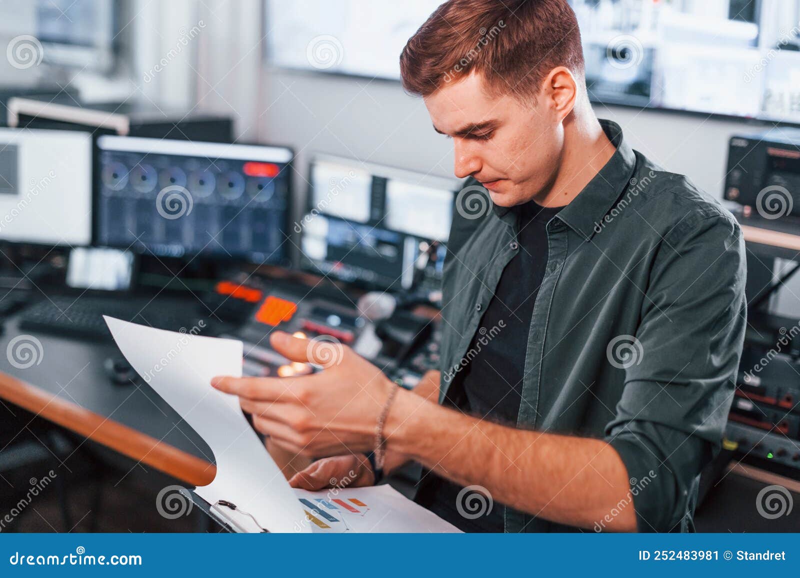 Document with Scenario. Young Man is Indoors in the Radio Studio is ...