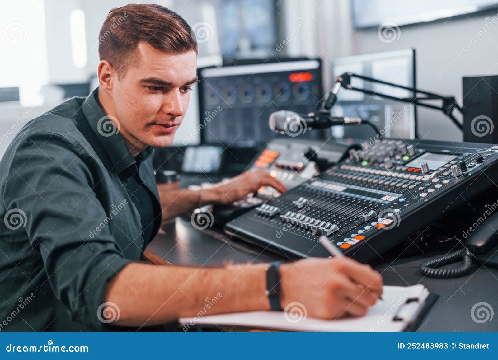 Document with Scenario. Young Man is Indoors in the Radio Studio is ...