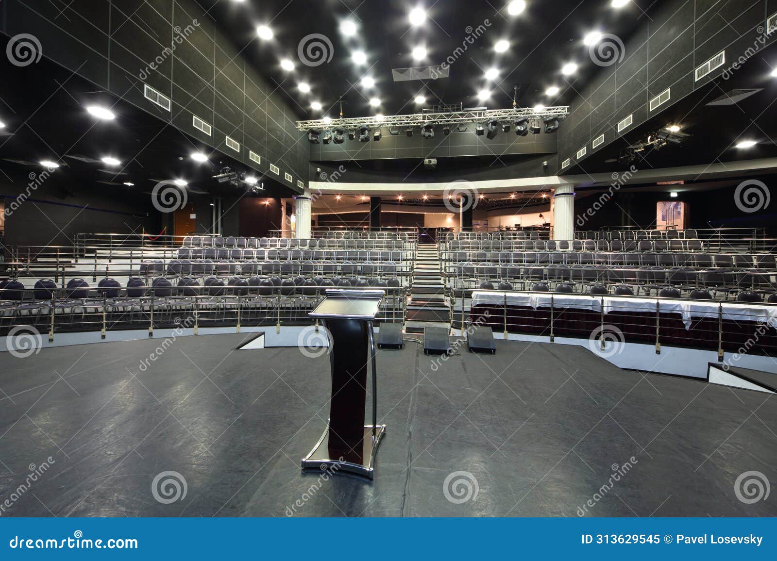 Document Stand on Stage and Rows of Chairs with Handrails in Large Hall ...