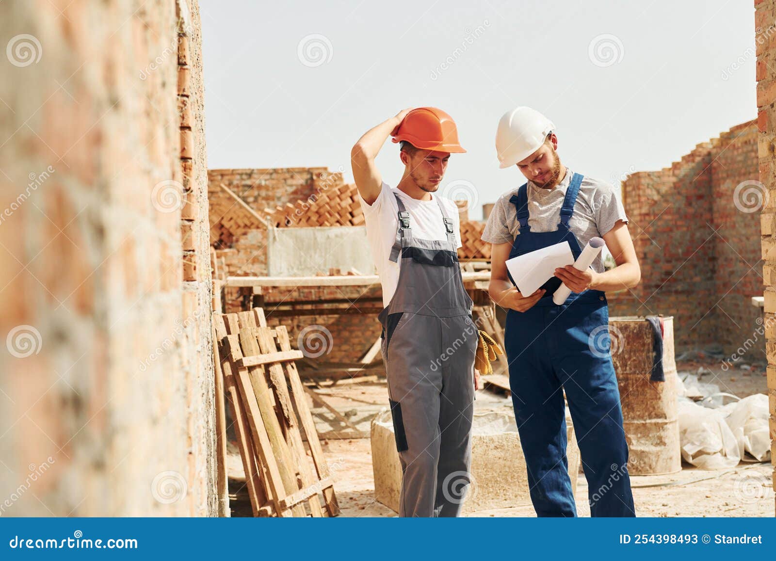 With Documents. Two Construction Workers is Together at the Building ...