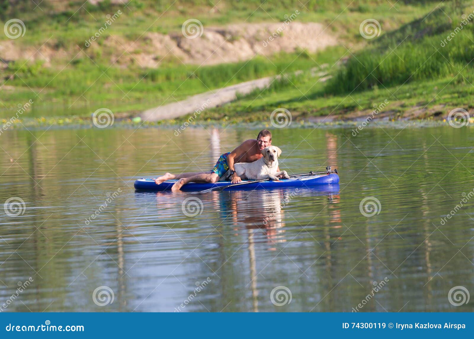 The Dog and the Man Float by the Boat on the Lake. Stock Image - Image ...