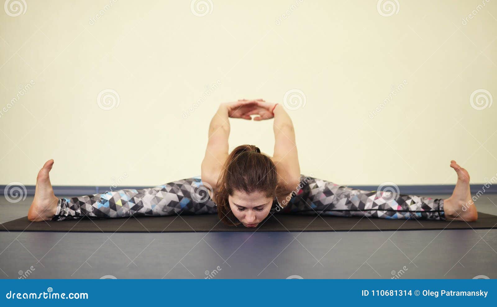 Doing Back Twists in Leg-split Position. Practising Yoga Asanas. Stock ...