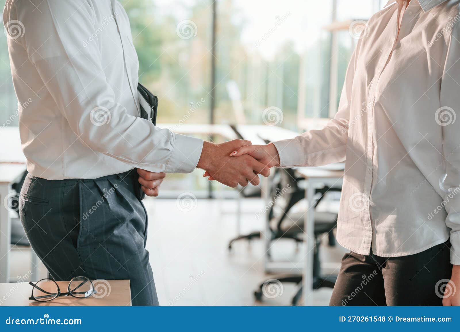 Doing Handshake. Man and Woman are Working in the Modern Office ...