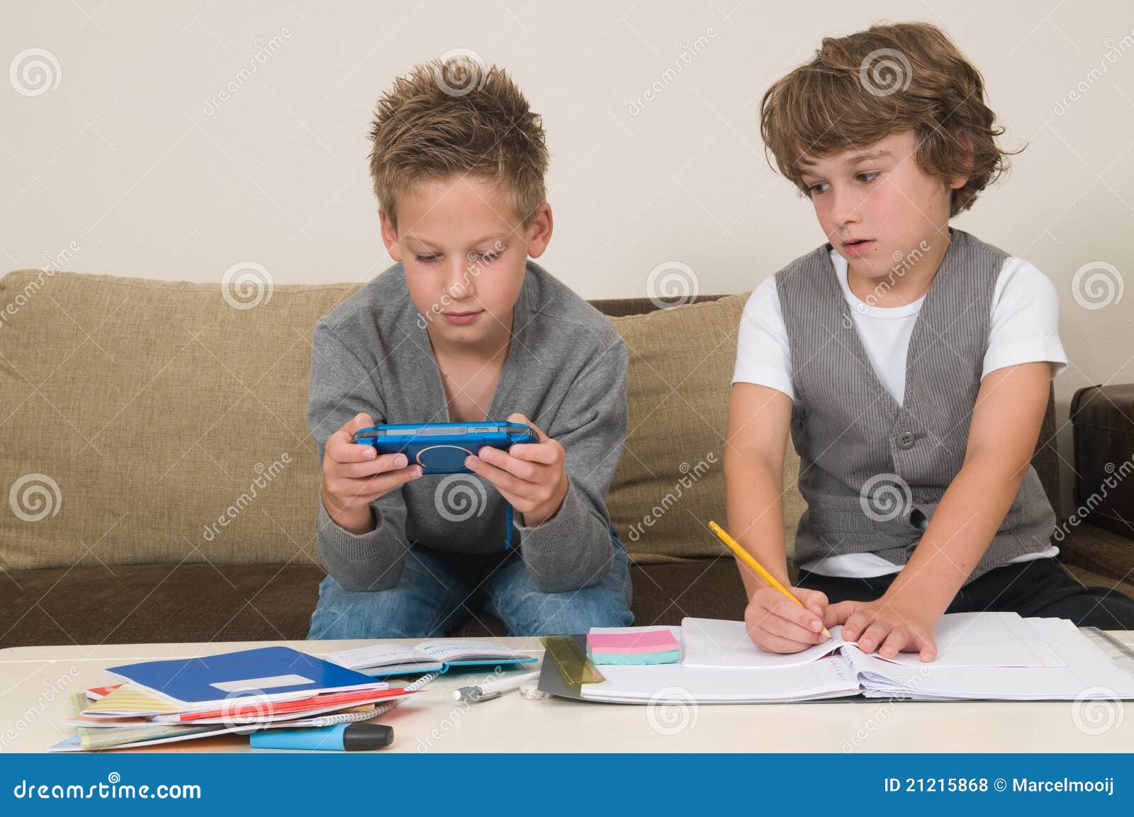 Doing Homework while Gaming Stock Photo - Image of jealous, gaming ...