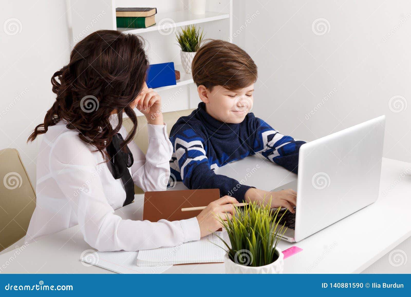 Doing Homework on the Laptop. Child Doing Homework and His Teacher ...