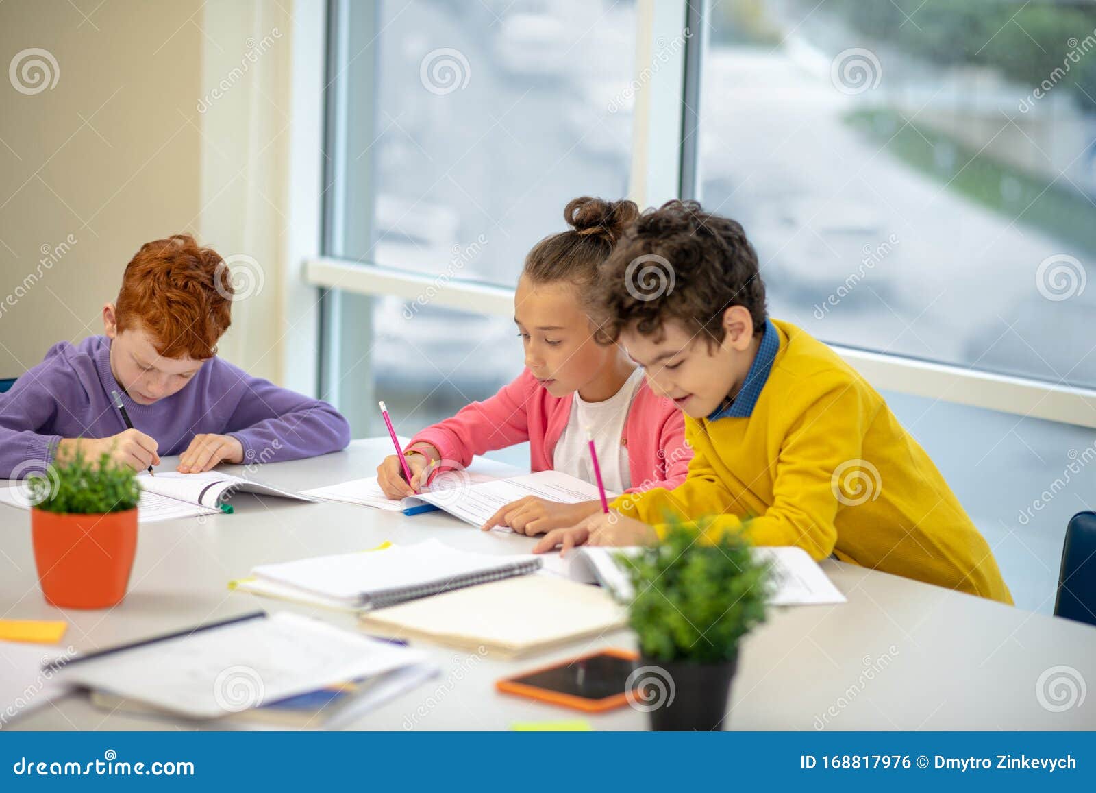 Three Pupils Working on Their Assignment Together Stock Photo - Image ... Three Pupils Working on Their Assignment Together Stock Photo - Image ...