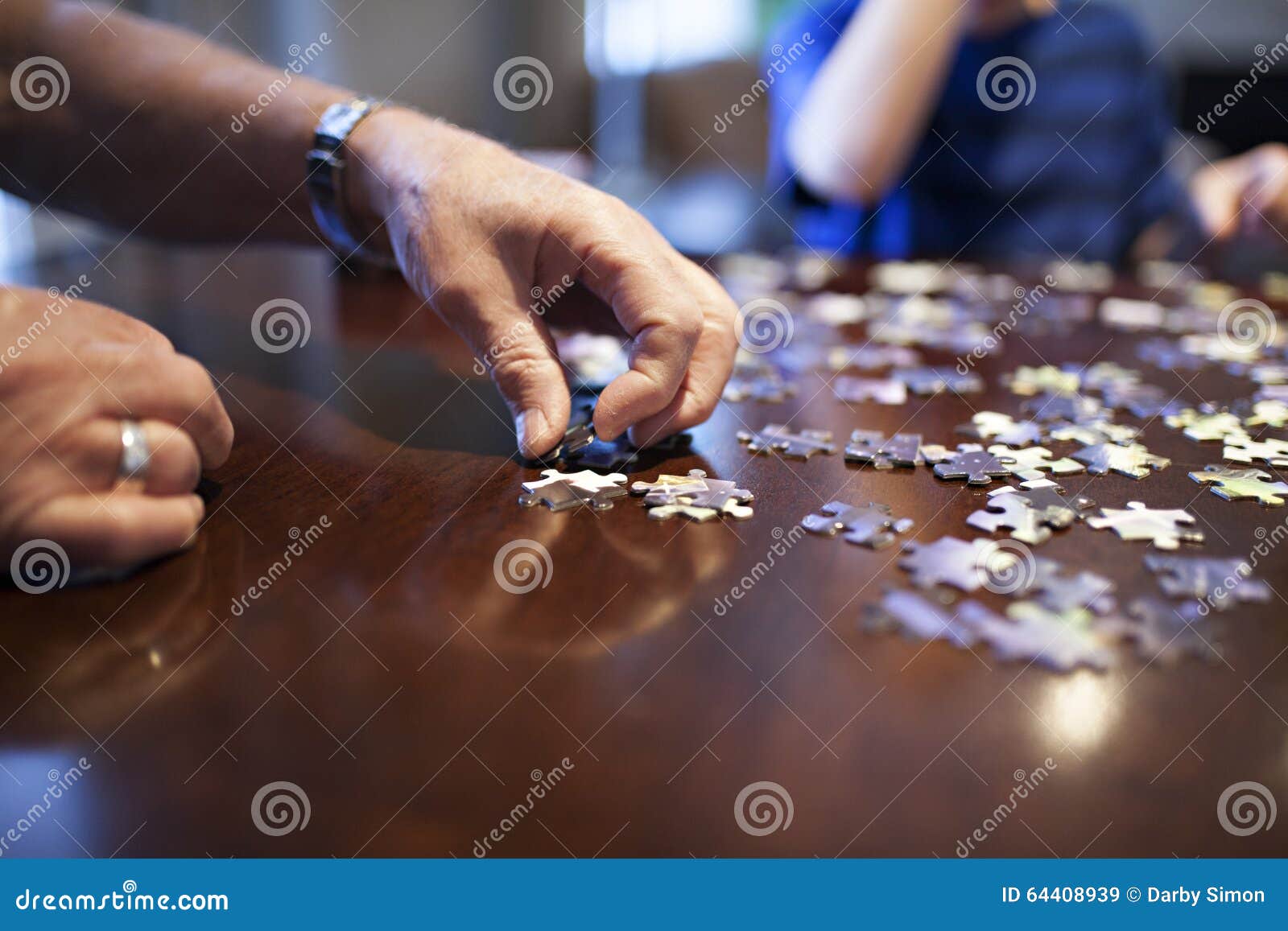 Doing a puzzle stock image. Image of table, jigsaw, hands - 64408939