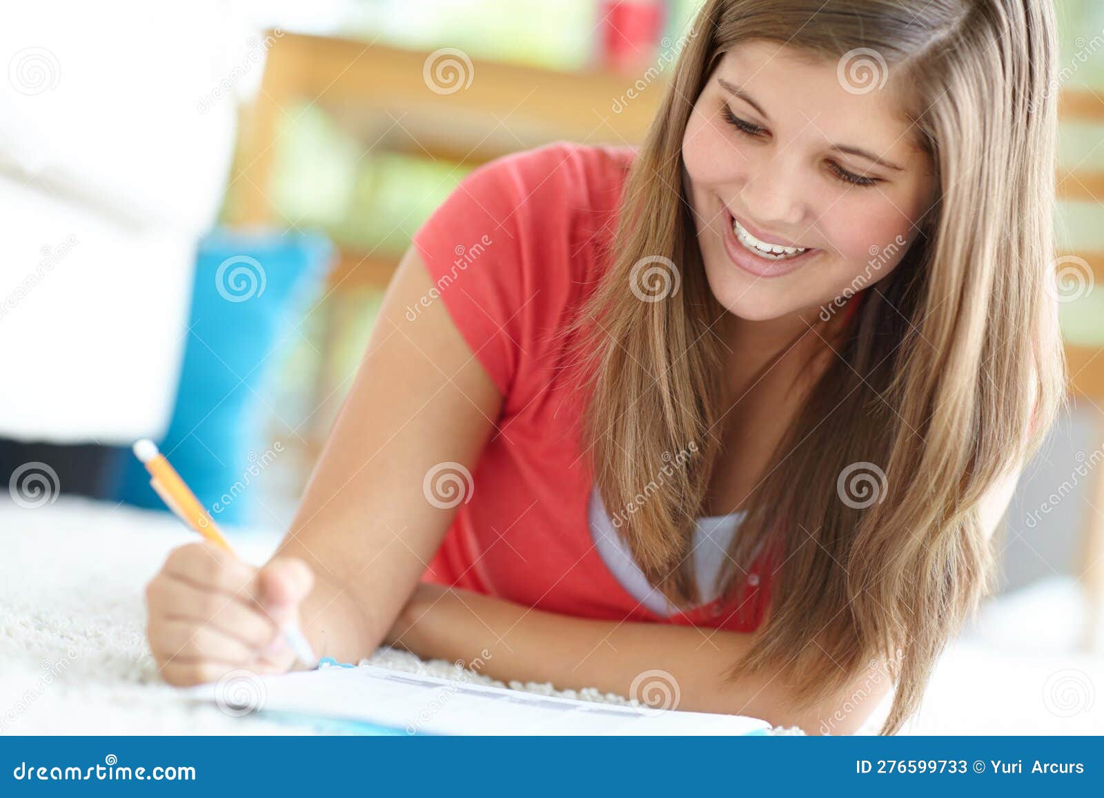 Doing Some College Work. a Pretty Student Doing Homework while Lying on ...