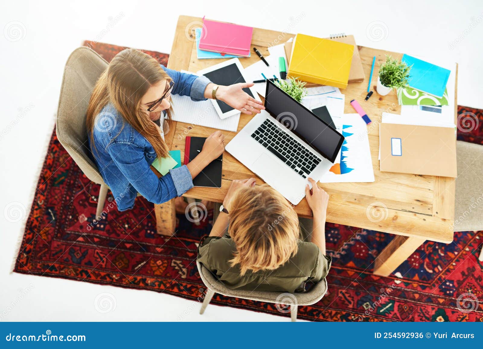 Doing Some Cramming in the Quad. High Angle Shot of Two Female ...