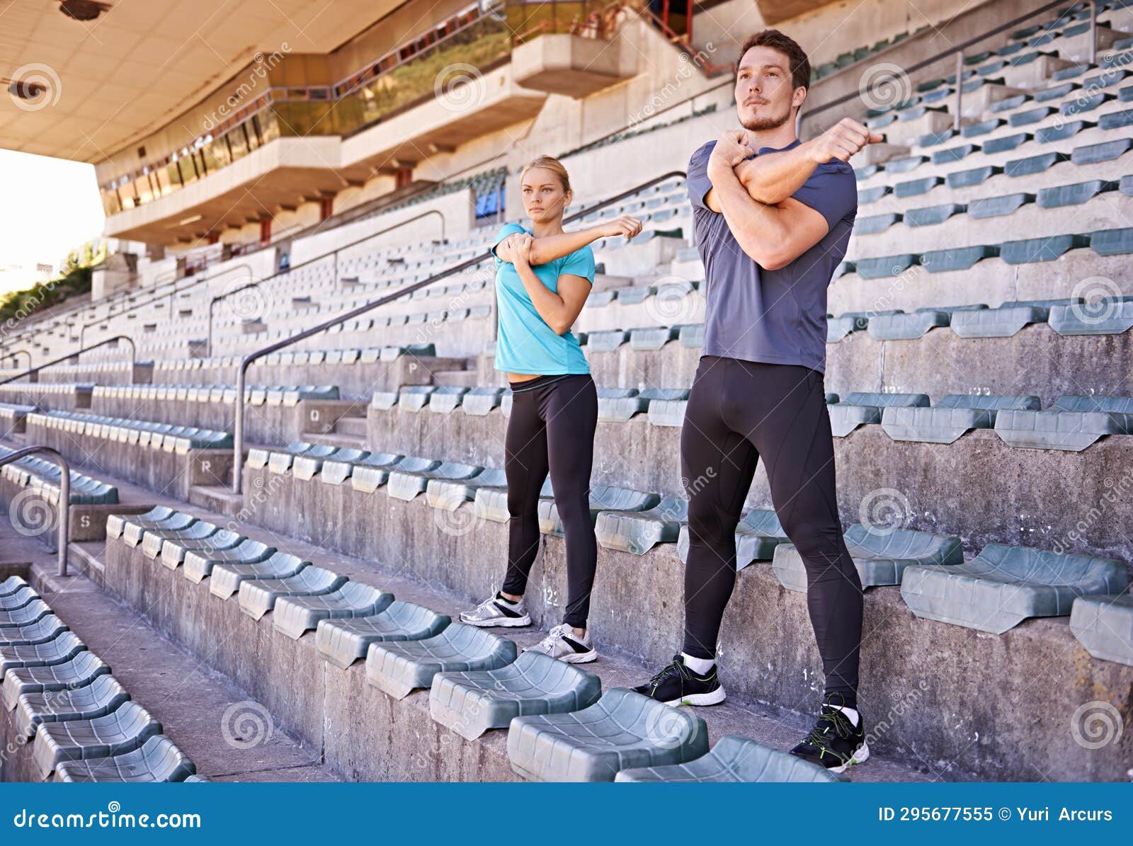 Doing a Team Stretch. Two Young People Stretching at an Athletics Arena. Stock Image - Image of ...