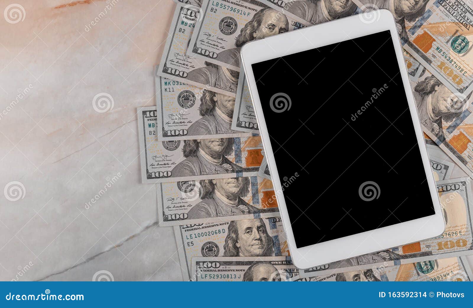 Dollar Bills and Digital Devices Tablet with Technology and Money Stock ...