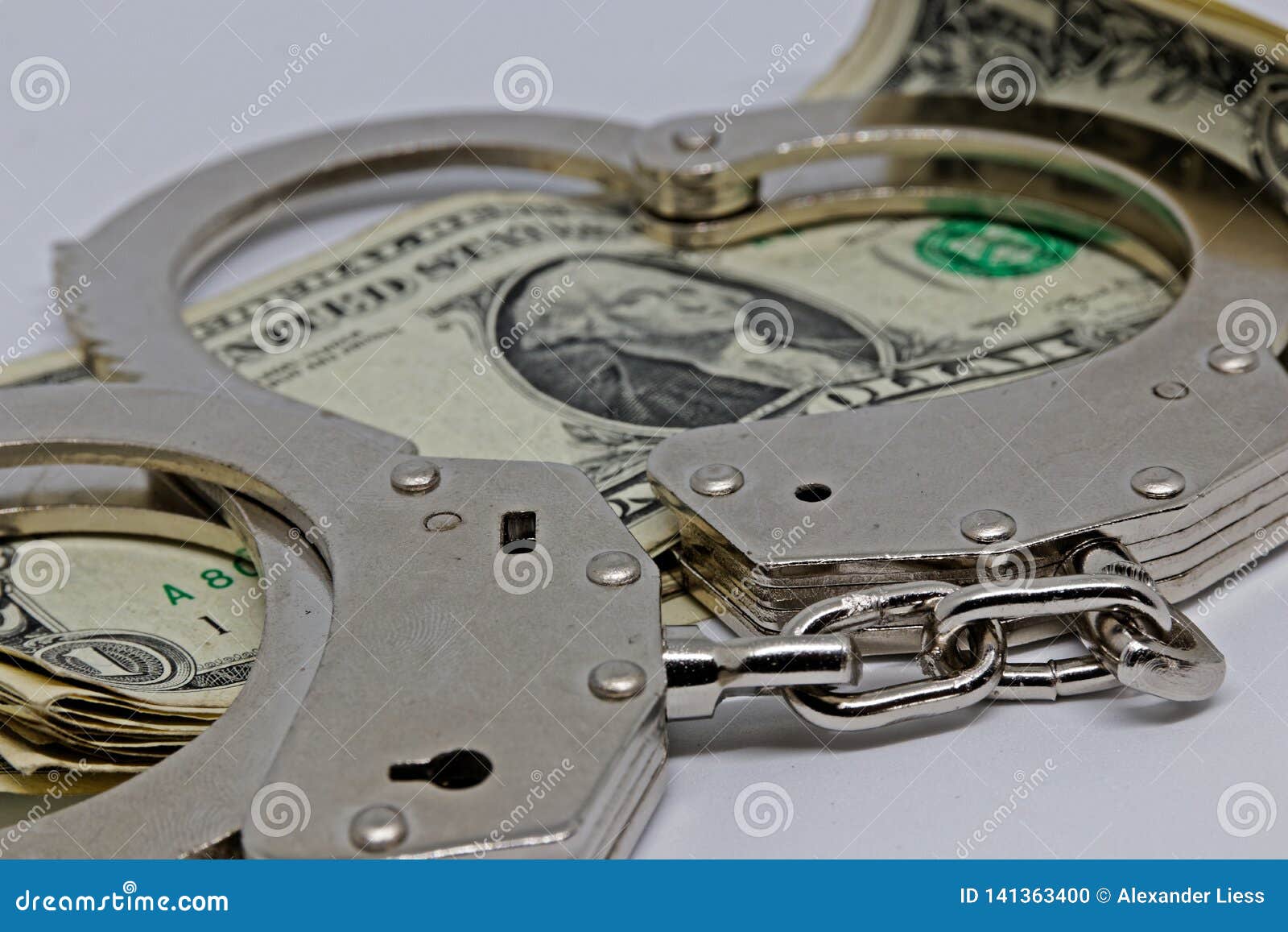 Metall handcuffs and money stock photo. Image of corruption - 141363400