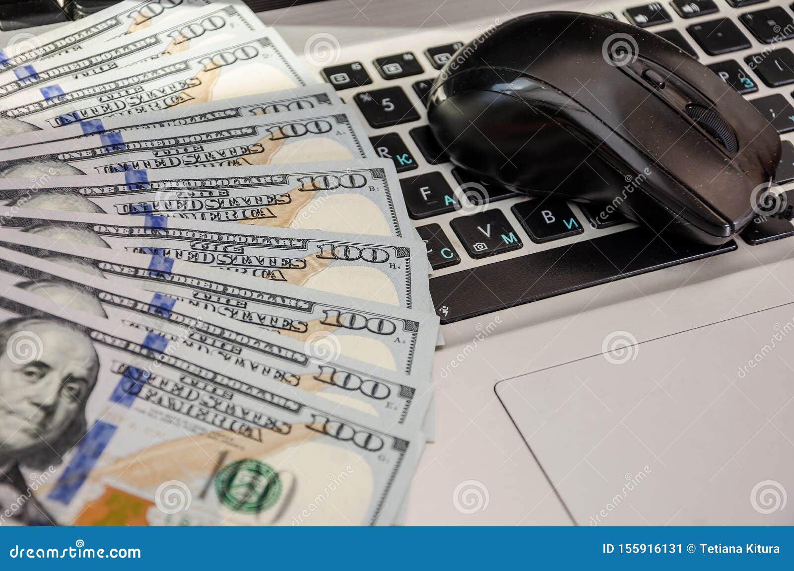 Dollars and Computer Mouse on Laptop Keyboard. Close-up. Stock Image ...