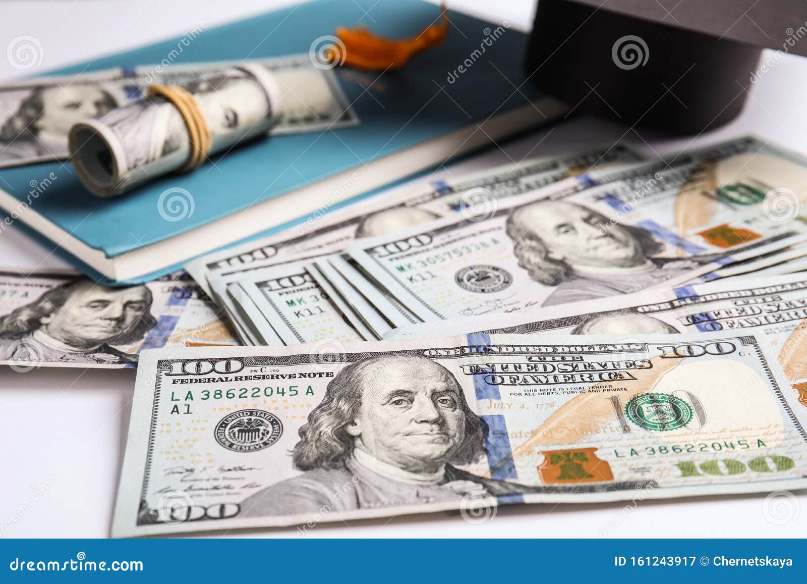 Dollars with Student Graduation Hat and Book. Tuition Fees Concept ...