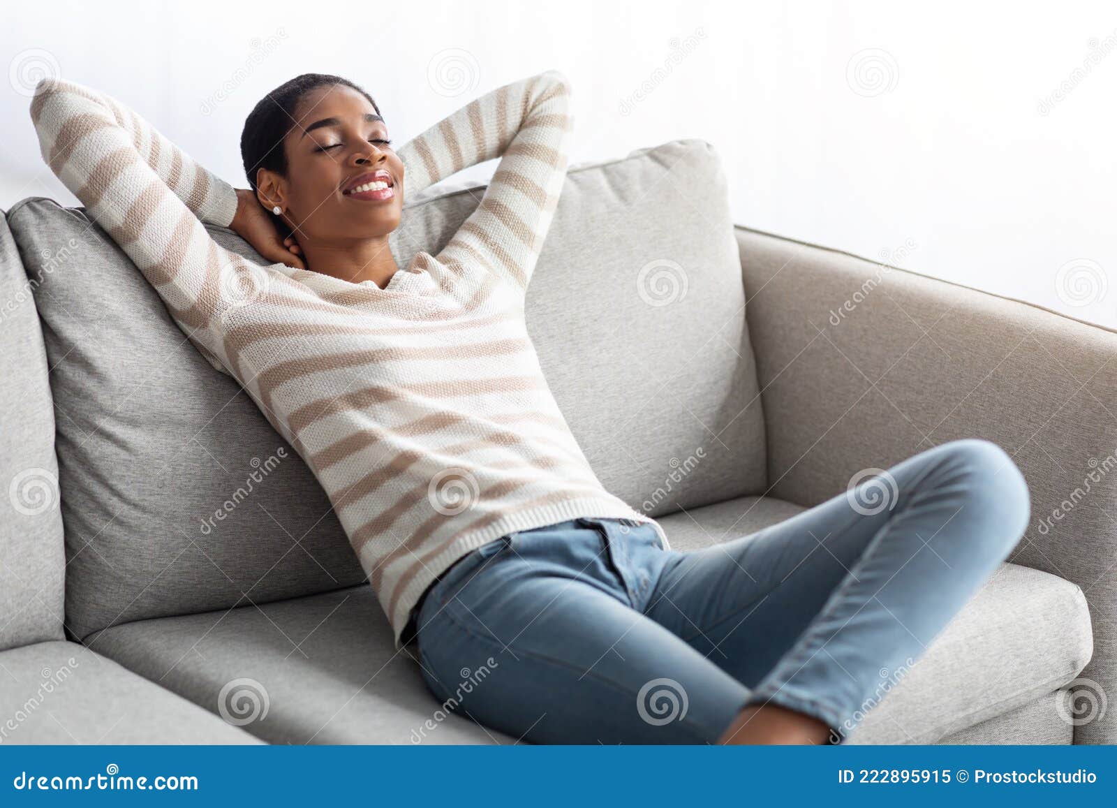 Domestic Comfort Relaxed African American Woman Leaning Back On Couch
