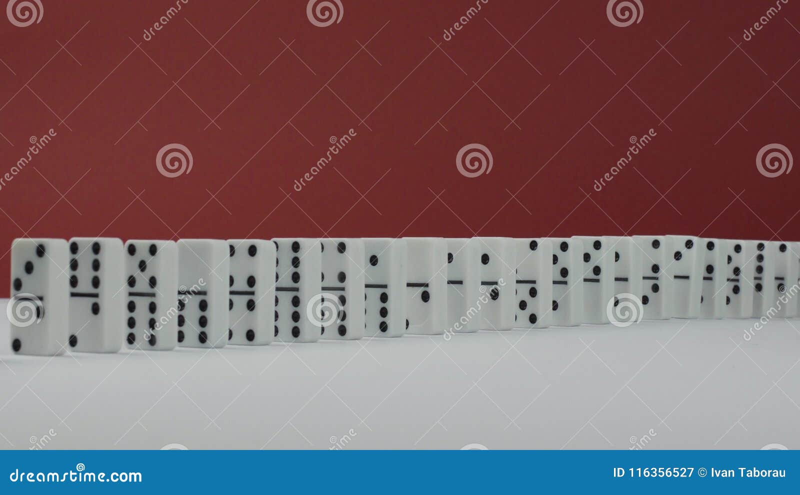 Domino Effect - a Series of Dominoes Falling Down the Chain on Red ...