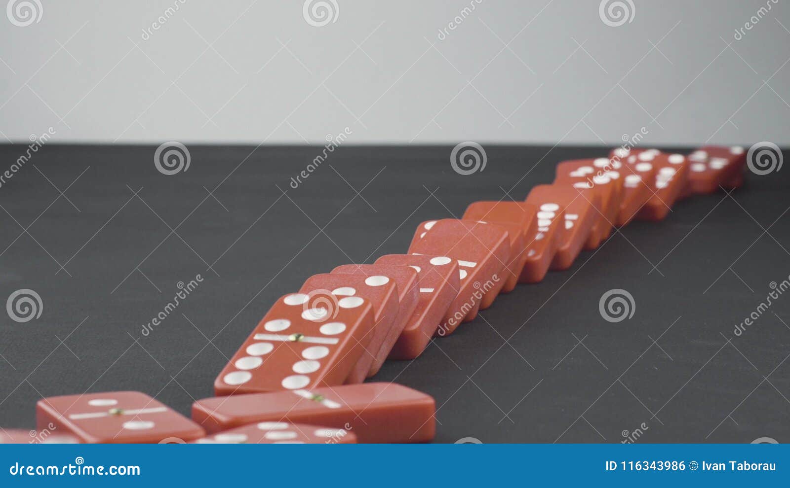 Domino Effect - a Series of Red Dominoes Falling Down the Chain Stock ...