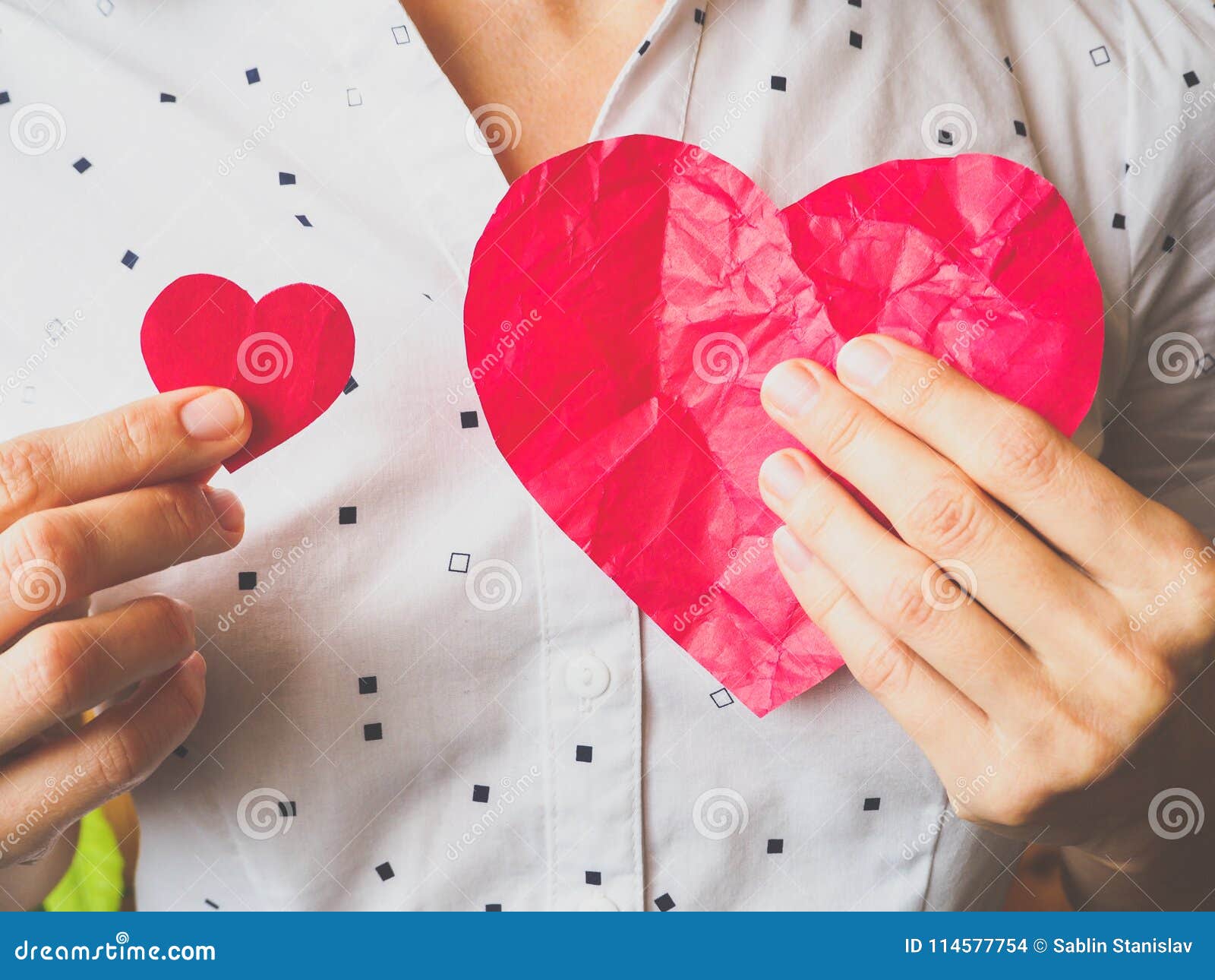 Donated Heart. Large and Small Red Heart in His Hand. Stock Photo ...