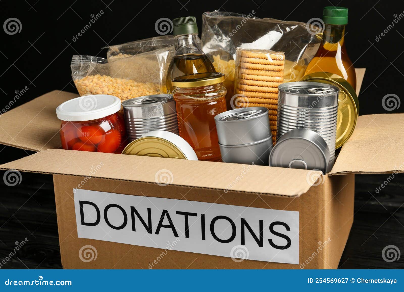 Donation Box with Food on Black Table, Closeup Stock Image - Image of ...